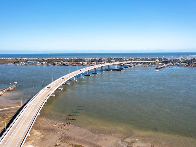 This causeway curves through paradise like a concrete smile, connecting mainland dreams to island realities.