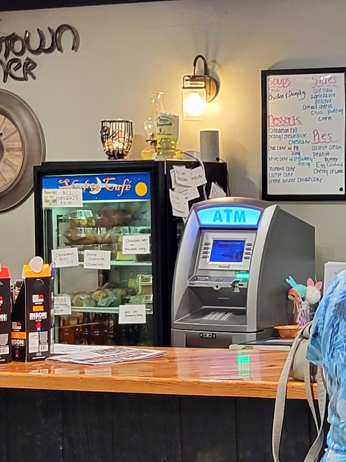 The corner where dessert specials tempt you from behind glass while the ATM stands ready for when you inevitably order one of everything.