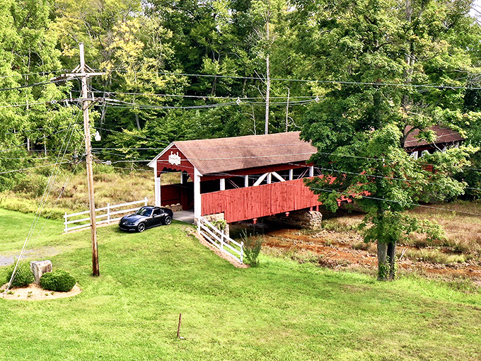 Bird's eye view of rural perfection. The bridge nestles into its green surroundings like it grew there naturally, a splash of red amid Pennsylvania's lush landscape.