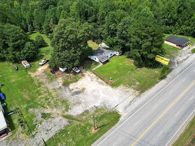 Rural simplicity at its finest &ndash; a modest home nestled among towering trees, where porch sitting is still an art form.