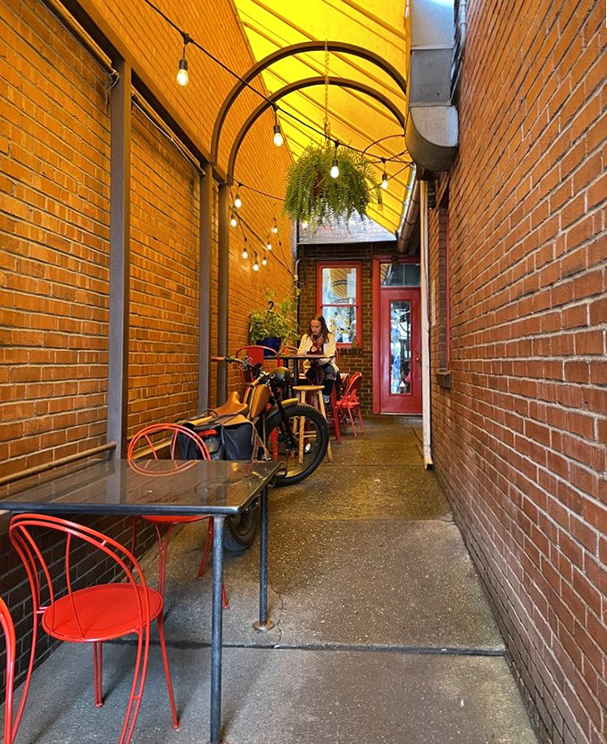 The charming alley dining area feels like a secret passage to Italy, complete with string lights and brick walls.