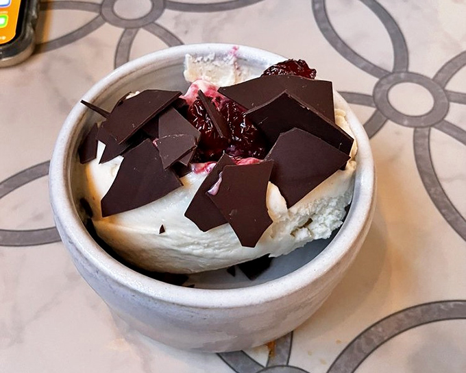 Chocolate shards standing like modern art atop creamy gelato. Dessert that satisfies both your sweet tooth and aesthetic sensibilities.