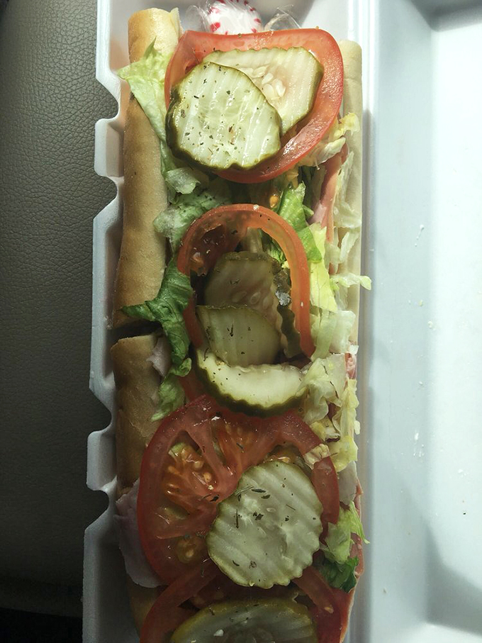 A work of edible art where each ingredient is placed with purpose&mdash;crisp lettuce, juicy tomatoes, and pickles arranged like jewels in a culinary crown.