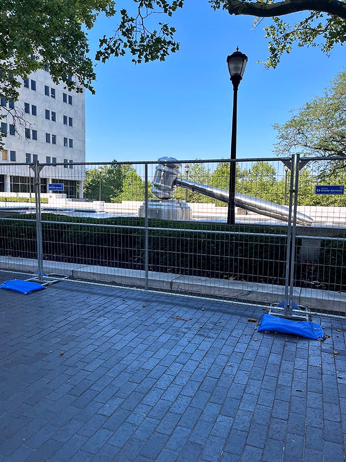 Even behind temporary fencing, the gavel commands attention&mdash;proof that great public art shines through any obstacle.