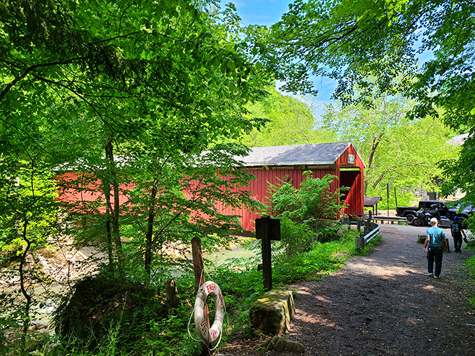 Spring brings the bridge to life with vibrant greens, as visitors stroll the pathway beside this crimson landmark that's been stopping traffic since Ulysses S. Grant was president.