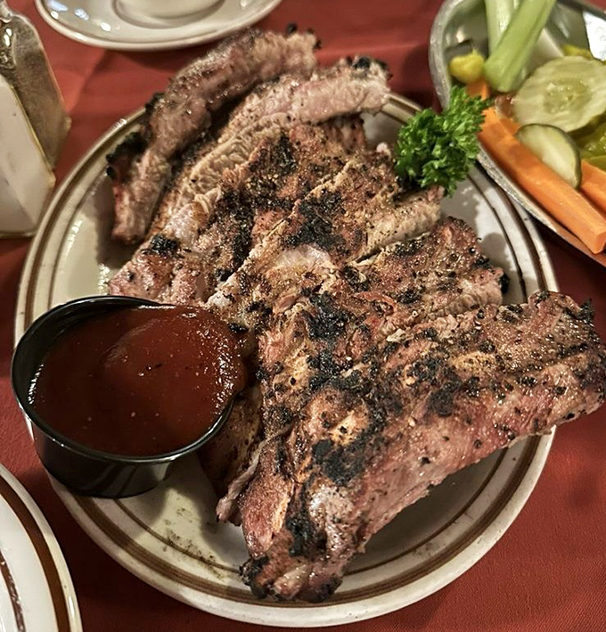 Ribs with the perfect smoke ring and char that would make cavemen weep with joy. The sauce cup isn't necessary, but it's there if you want to gild the lily.