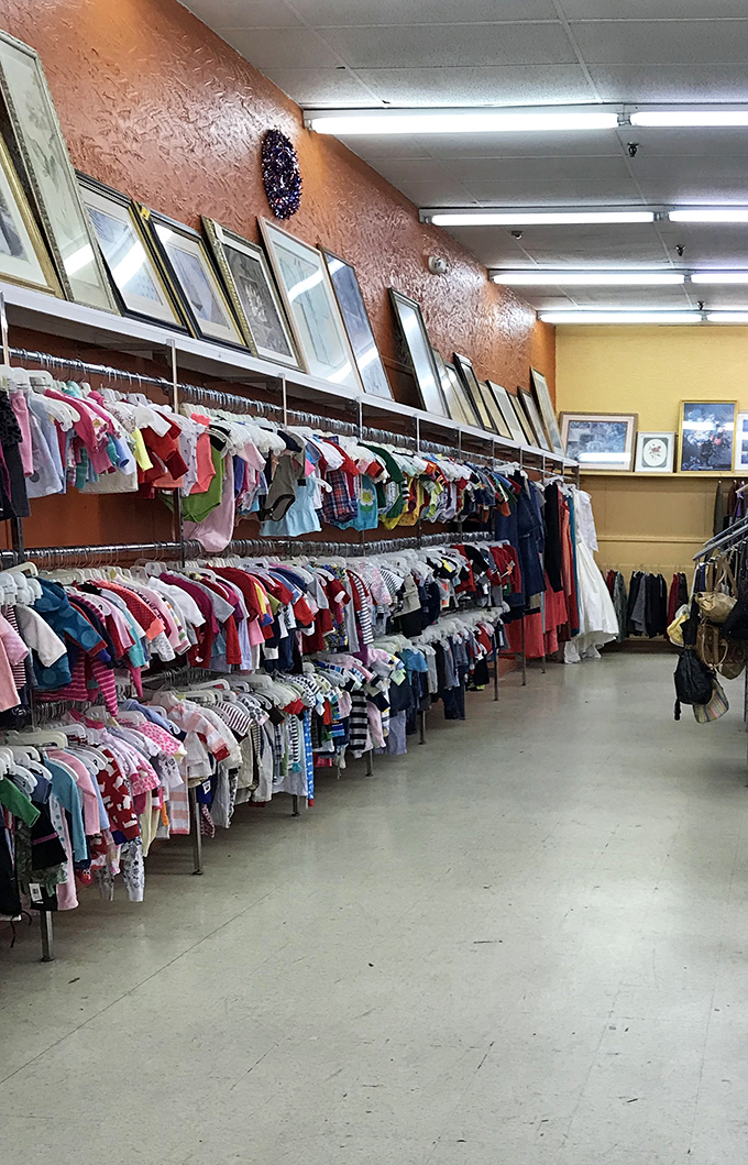 Children's clothes hang in colorful rows, ready for their next playground adventure with new tiny owners.