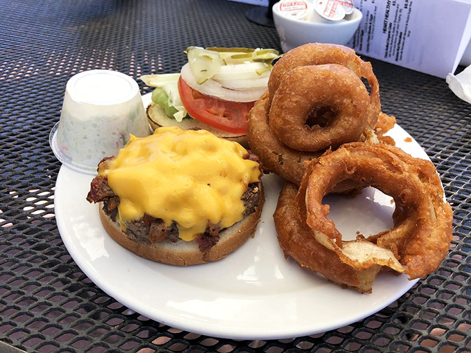 A burger and onion rings that make you question why anyone would ever need fancy ingredients when the classics are this good.