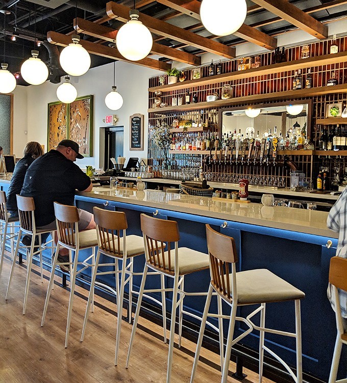 The bar isn't just stocked – it's a liquid library of spirits waiting to complement your Southern feast.