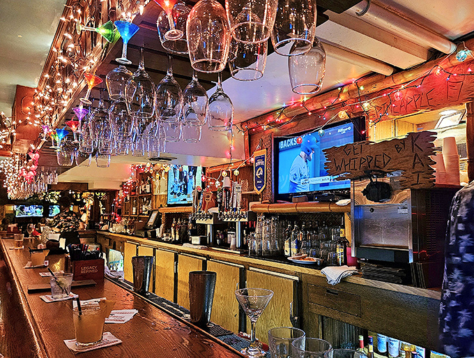 The bar at Damon's doesn't just serve drinks; it crafts liquid souvenirs from a time when cocktails were an art form and glasses hung like chandeliers.