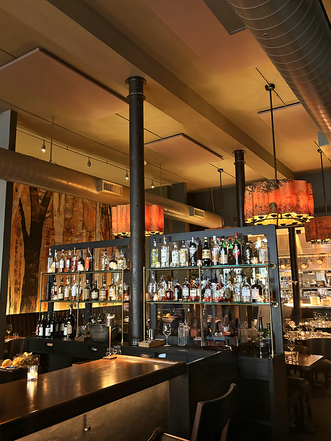 A bar that takes its spirits seriously. Those amber-lit bottles stand like soldiers ready to be deployed in service of your perfect evening.