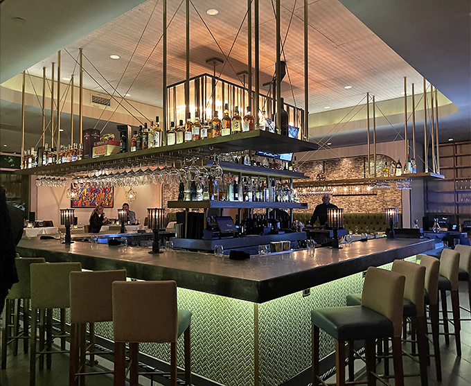 The suspended bar shelving defies both gravity and ordinary design. This is where spirits are elevated, literally and figuratively.