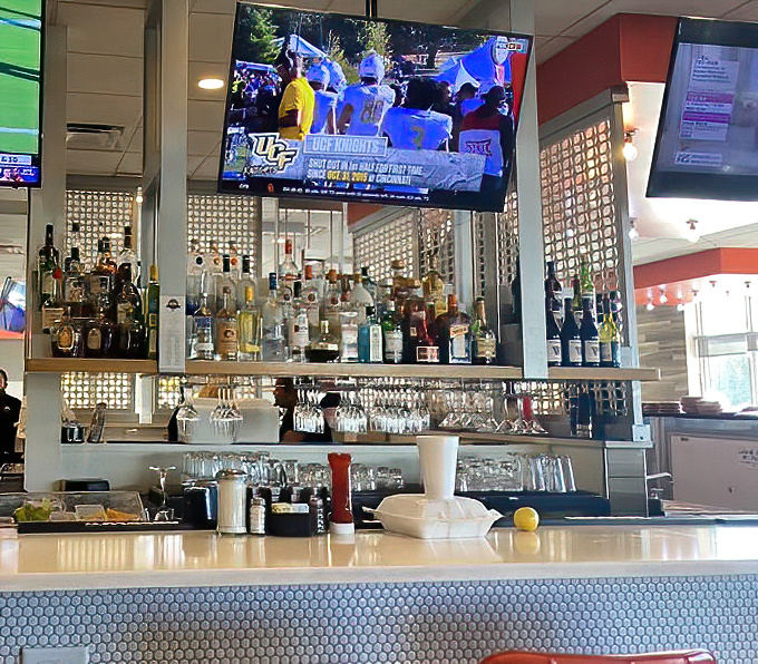 The bar area balances sports-watching with serious eating—a command center for those who appreciate both teams and good taste.