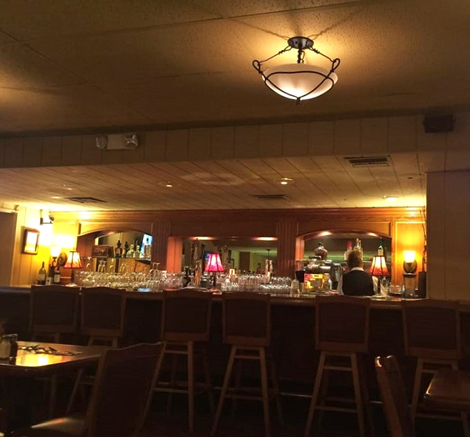 The bar area glows with amber light in the evening hours, where barstools have supported the weight of countless stories and celebrations.