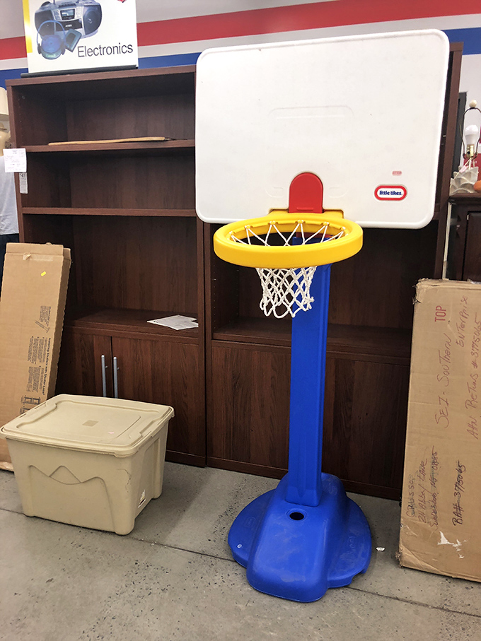 A Little Tikes basketball hoop stands ready for action &ndash; because someone's outgrown toy becomes another family's backyard championship court.