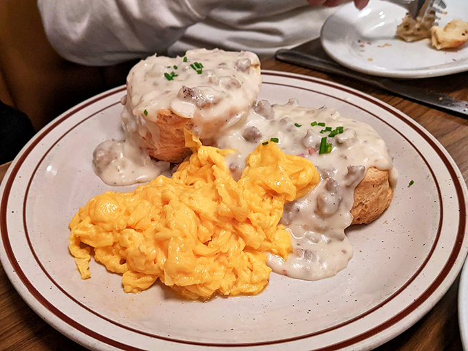 Biscuits swimming in creamy gravy alongside scrambled eggs the color of sunshine. Comfort food that hugs you from the inside out.