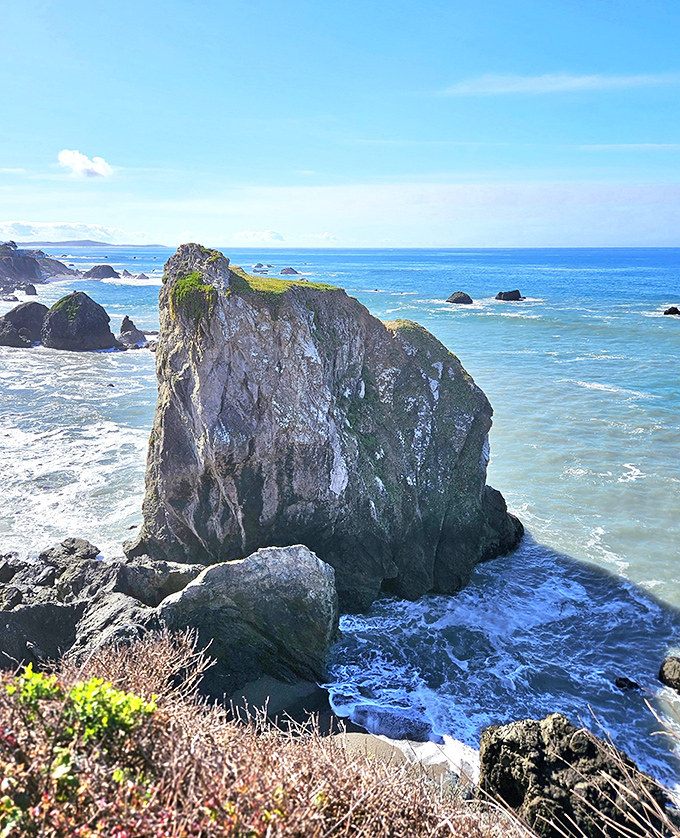 Rock formations stand guard over the coastline like ancient coastal sentinels.