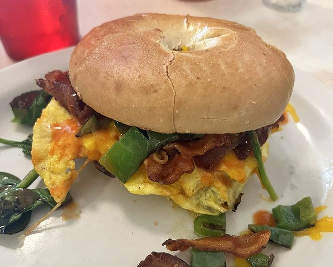 The breakfast sandwich&mdash;where a humble bagel becomes the stage for a morning performance of eggs, cheese, and vegetables in perfect harmony.