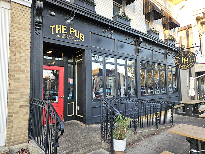 The Pub on Broadway's classic black storefront and red door beckon with promises of cold drinks and warm conversation.
