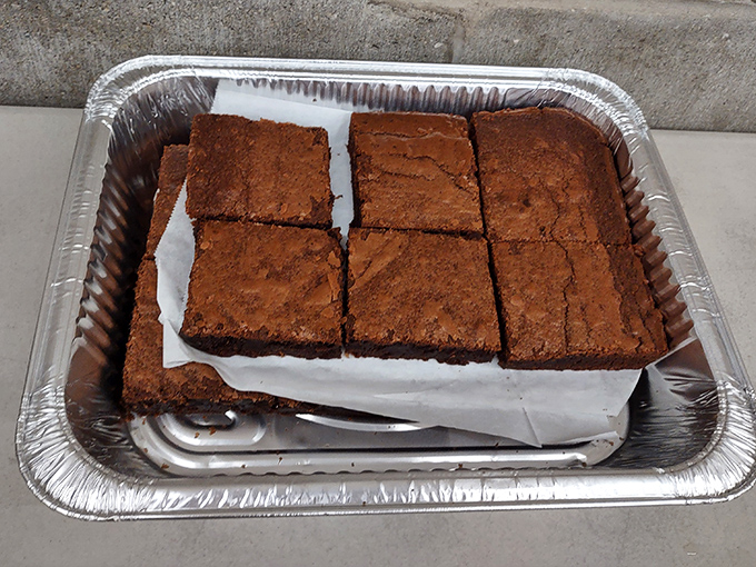 Homemade brownies cut thick and proud &ndash; the kind of dessert that makes you reconsider whether you really need that extra BBQ rib.