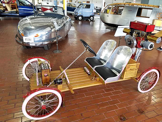 Early automotive experimentation produced this charming buckboard-style vehicle with bicycle-inspired wheels and engineering.