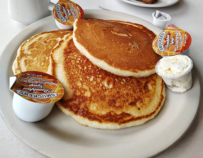 Pancakes that look like they were painted by Norman Rockwell himself&mdash;golden, fluffy, and waiting patiently for their maple bath.