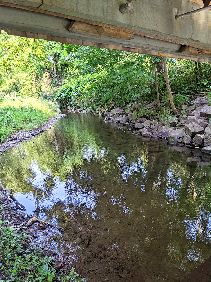 Evening transforms the white bridge into a glowing landmark, where visitors gather to experience the structure's timeless appeal under starlight.