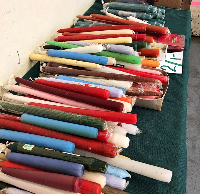 A rainbow of vintage candles, never lit but somehow still illuminating the past with their vibrant, waxy nostalgia.