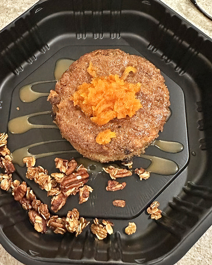 This dessert isn't just served&mdash;it's presented. A circle of cake surrounded by nuts, with what appears to be fruit compote. Sweet dreams are made of this.