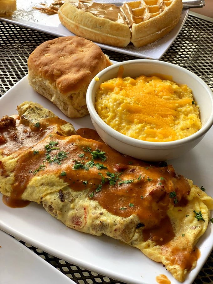 Fluffy cheddar grits alongside that perfectly folded omelet create a harmony that would make any Southern grandmother proud.
