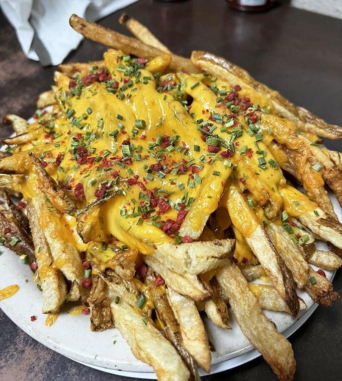 Loaded cheese fries that laugh in the face of moderation &ndash; a glorious mess of crispy potatoes, melted cheese, bacon bits and chives that demands to be shared.