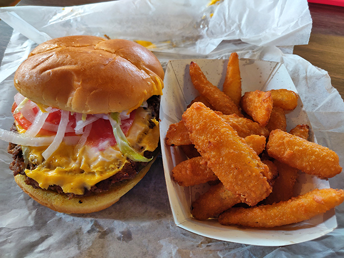 A proper cheeseburger with all the fixings alongside golden potato wedges&mdash;proof that sometimes the simplest pleasures are the most satisfying.