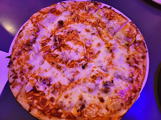 Under purple lights, this Buffalo Chicken pizza transforms into a rock star—spicy, creamy, and ready for its close-up.