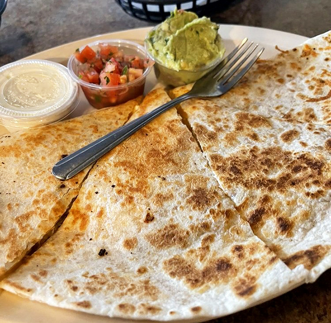 A quesadilla that takes no prisoners&mdash;golden, crispy, and ready for its close-up. Those sides of salsa and guacamole are standing by for duty.