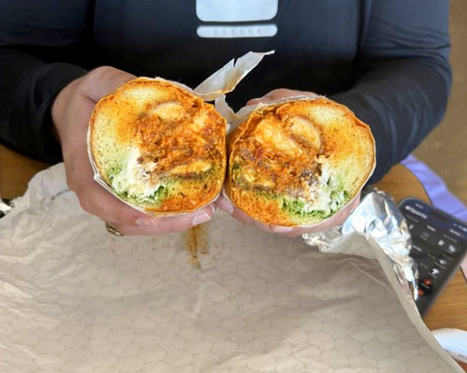 The chicken sandwich halves reveal their cross-section like geological strata, each layer contributing to the flavor landscape.