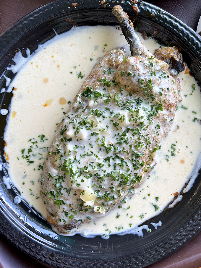 This chile relleno swimming in creamy sauce isn't just food&mdash;it's edible poetry with a kick that whispers "worth every calorie."