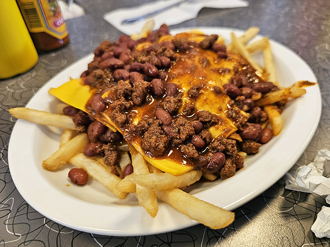Chili cheese fries that laugh in the face of diet culture. A beautiful mess worth every napkin and calorie.