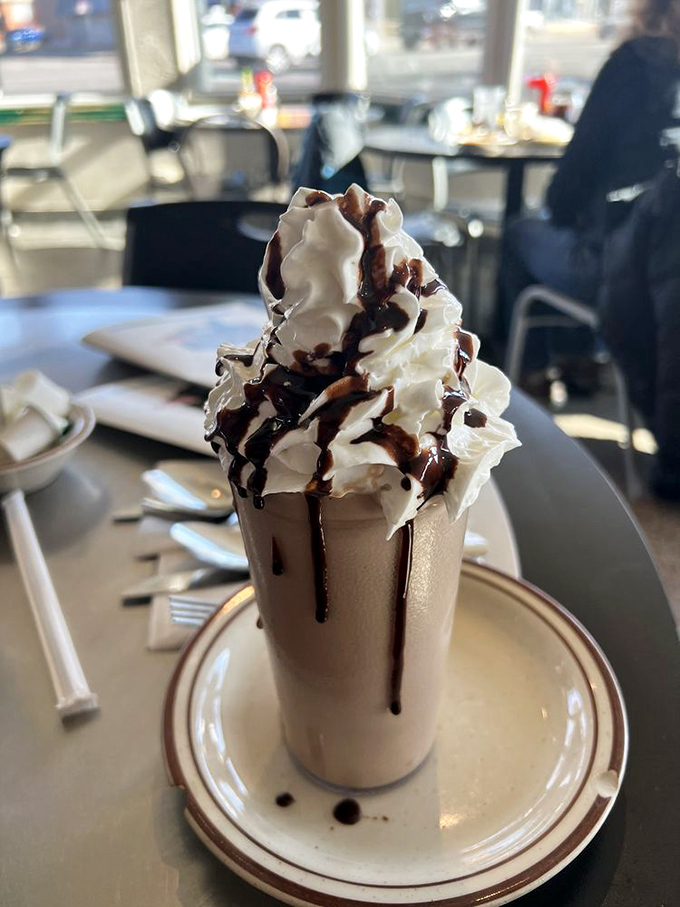 This chocolate milkshake isn't just a drink; it's a commitment. That mountain of whipped cream deserves its own zip code.