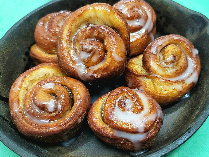Cinnamon rolls glistening with glaze, each spiral promising a journey from sweetly satisfying edge to that coveted gooey center.