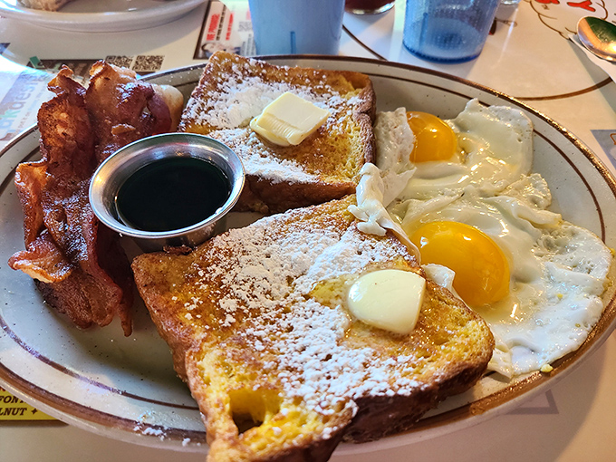 French toast dusted with powdered sugar, bacon crisped to perfection, and sunny-side-up eggs&mdash;breakfast doesn't get more textbook perfect than this.