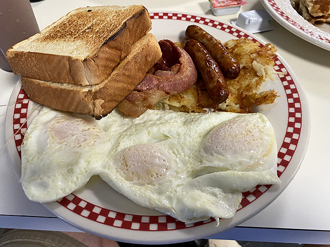 The classic breakfast plate&mdash;perfectly cooked eggs, golden toast, crispy hash browns, and breakfast meats arranged like a delicious solar system.