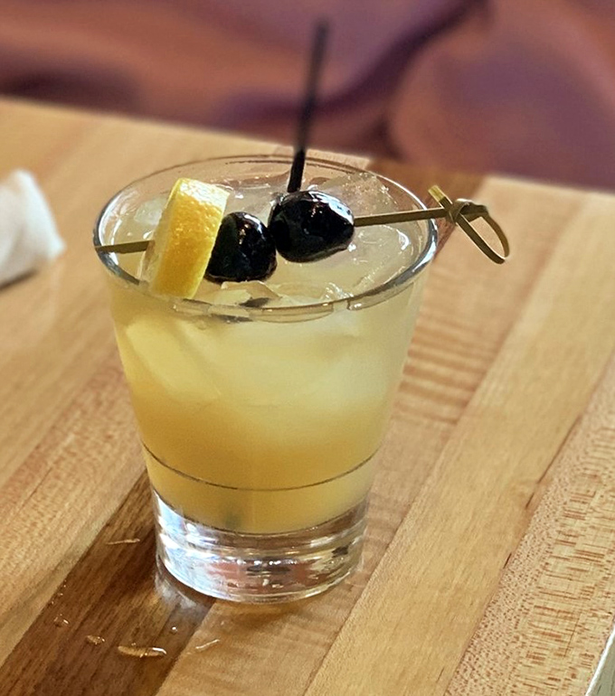 This cocktail garnished with cherries and citrus promises to be the perfect companion to your comfort food adventure.