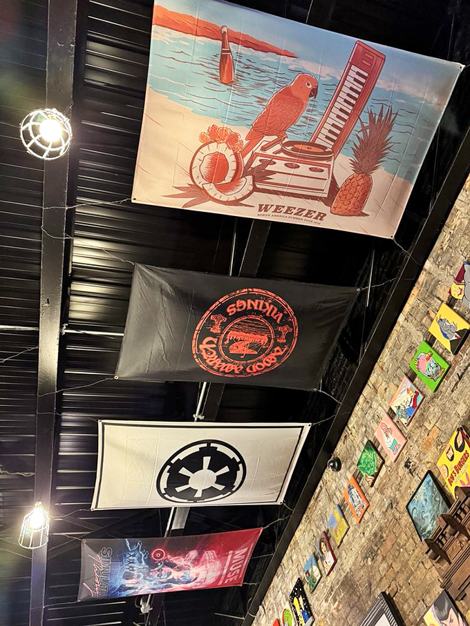 Rock meets smoke under these banners. The ceiling decor adds another layer to the rebellious spirit of a place that takes BBQ seriously but itself, not so much.