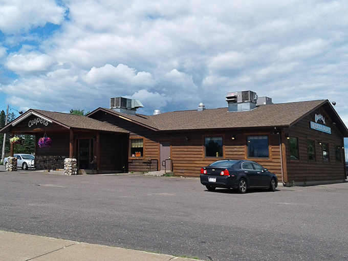 Coopers Restaurant embodies Northwoods dining with its rustic log cabin exterior, promising hearty meals after a day of Hayward adventures.