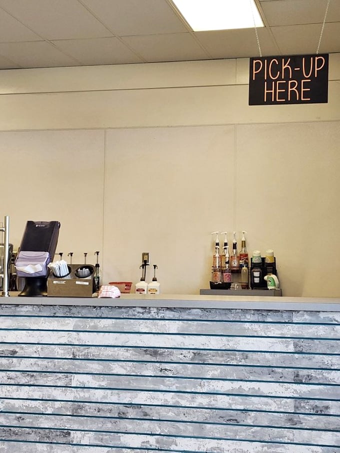 The "Pick-Up Here" sign might as well say "Life-Changing Experiences Distributed at This Counter."