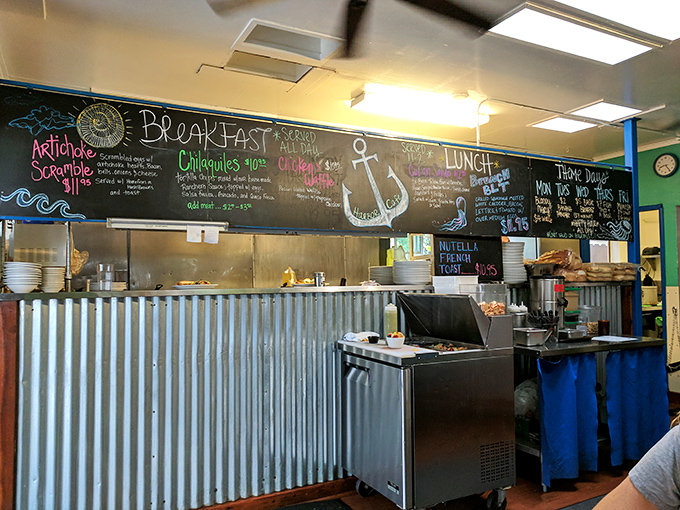 Behind this counter, breakfast dreams are born and coffee miracles happen daily, all under a whimsical green ceiling.