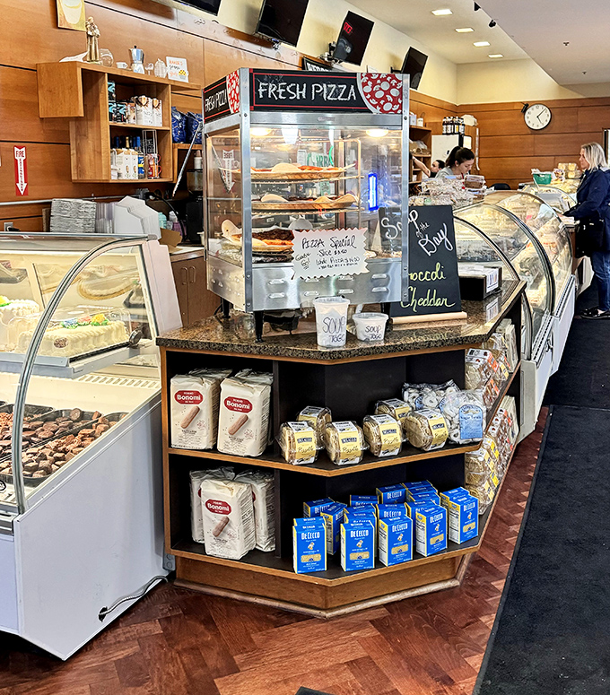 The bakery counter curves like a smile, offering everything from fresh pizza to traditional pastries in a display that's both art gallery and temptation factory.