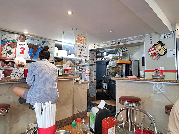Miami Heat memorabilia watches over diners like culinary guardian angels, blessing each bite with local sports pride.