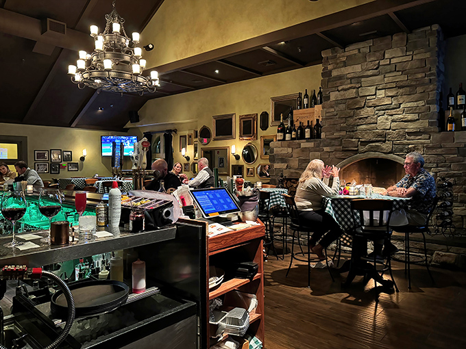 The bar area doesn't just serve drinks; it creates a cozy nook where the stone fireplace and rich wood tones make winter evenings feel like a warm embrace.