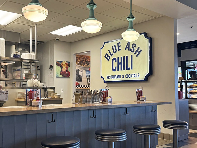 Counter seating offers front-row tickets to the culinary show, where blue accents echo the restaurant's name and chili-making magic happens nearby.